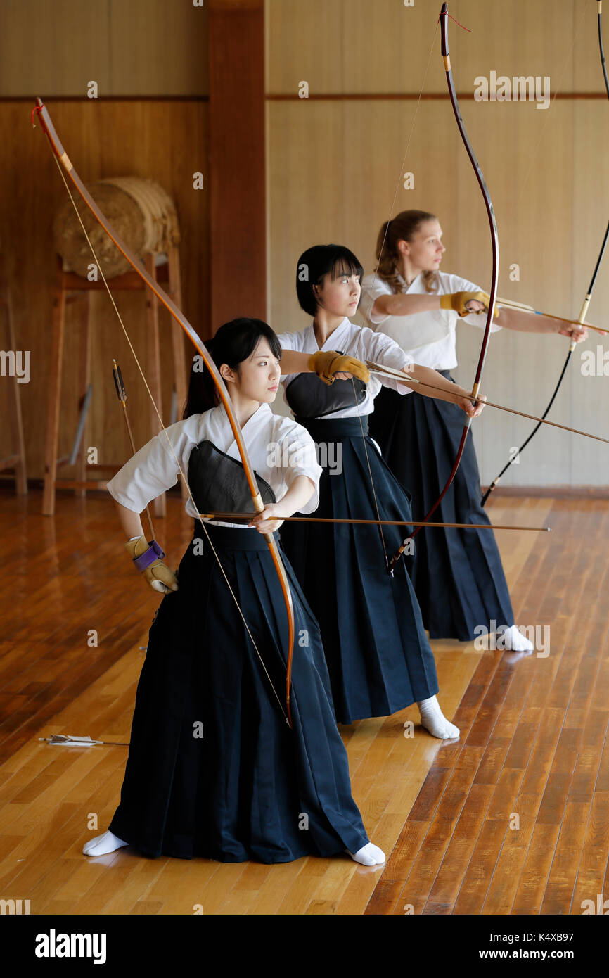 Multi-ethnic group of traditional archery athletes practicing Stock ...