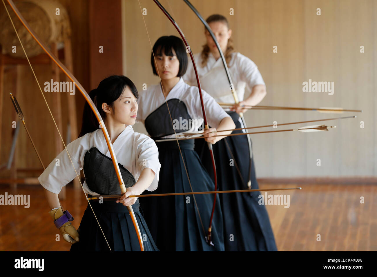 Multi-ethnic group of traditional archery athletes practicing Stock ...