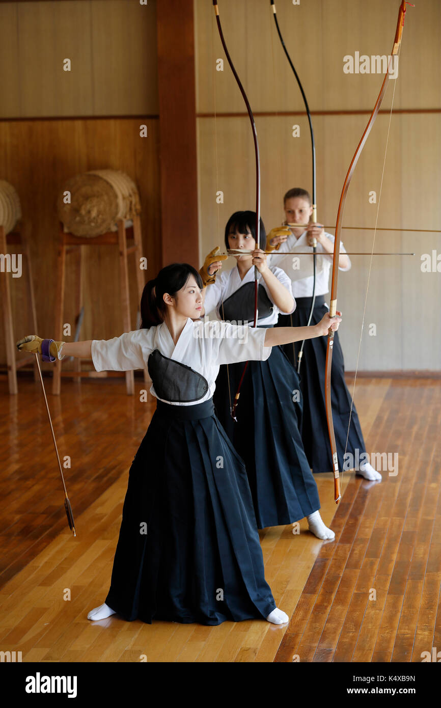 Multi-ethnic group of traditional archery athletes practicing Stock ...
