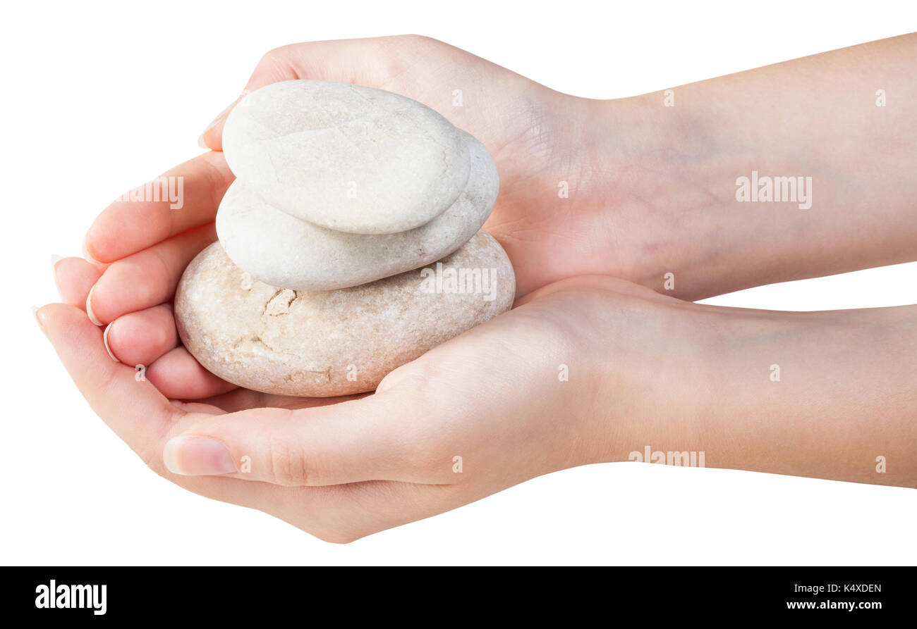 side view of pyramid from beach pebble in handful isolated on white ...