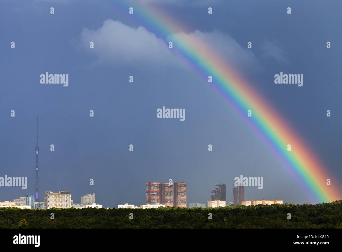 rainbow in dark blue sky over Moscow city with TV tower and ...