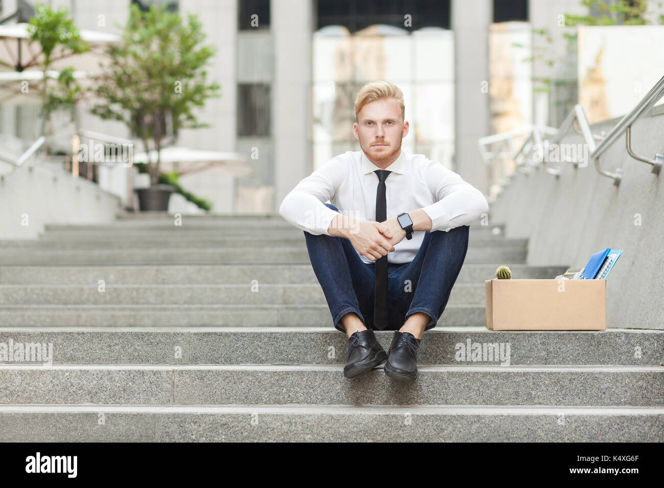 Unfair ginger worker sit on stair and seriosly looking at camera ...