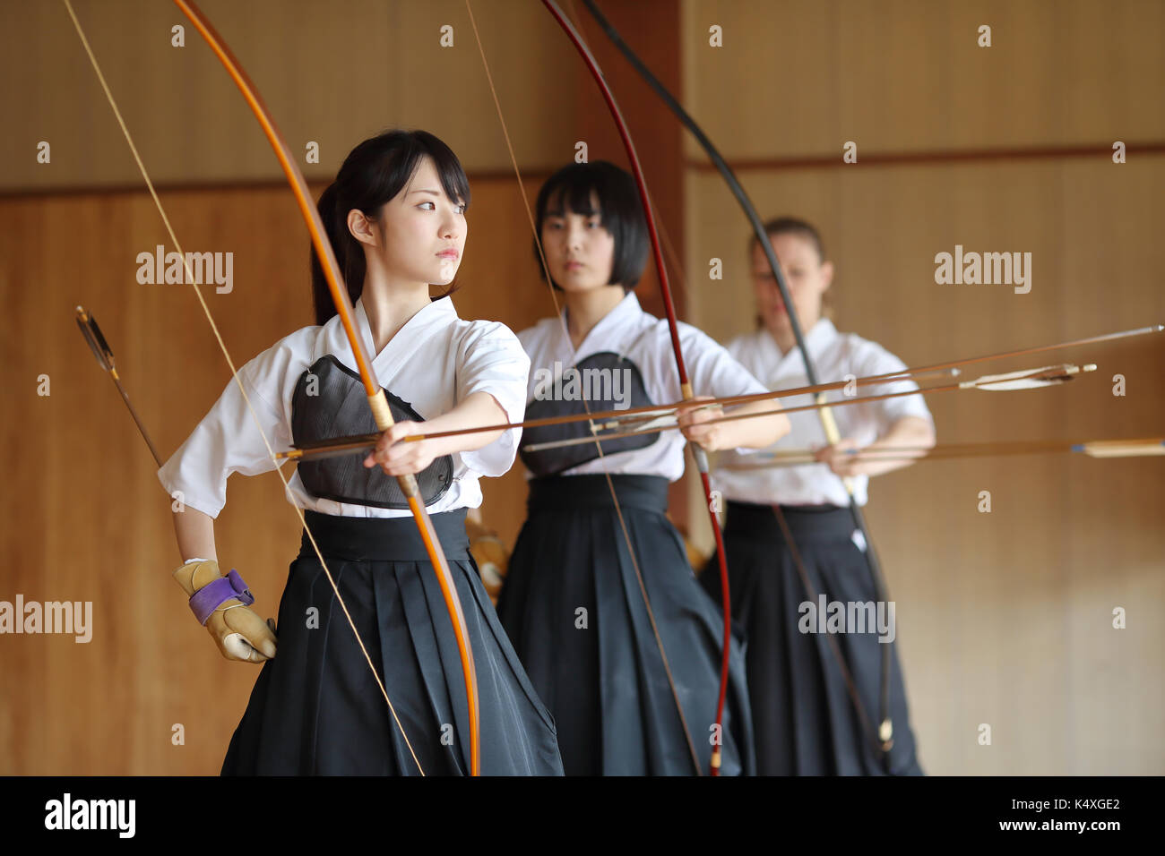 Multi-ethnic group of traditional archery athletes practicing Stock ...