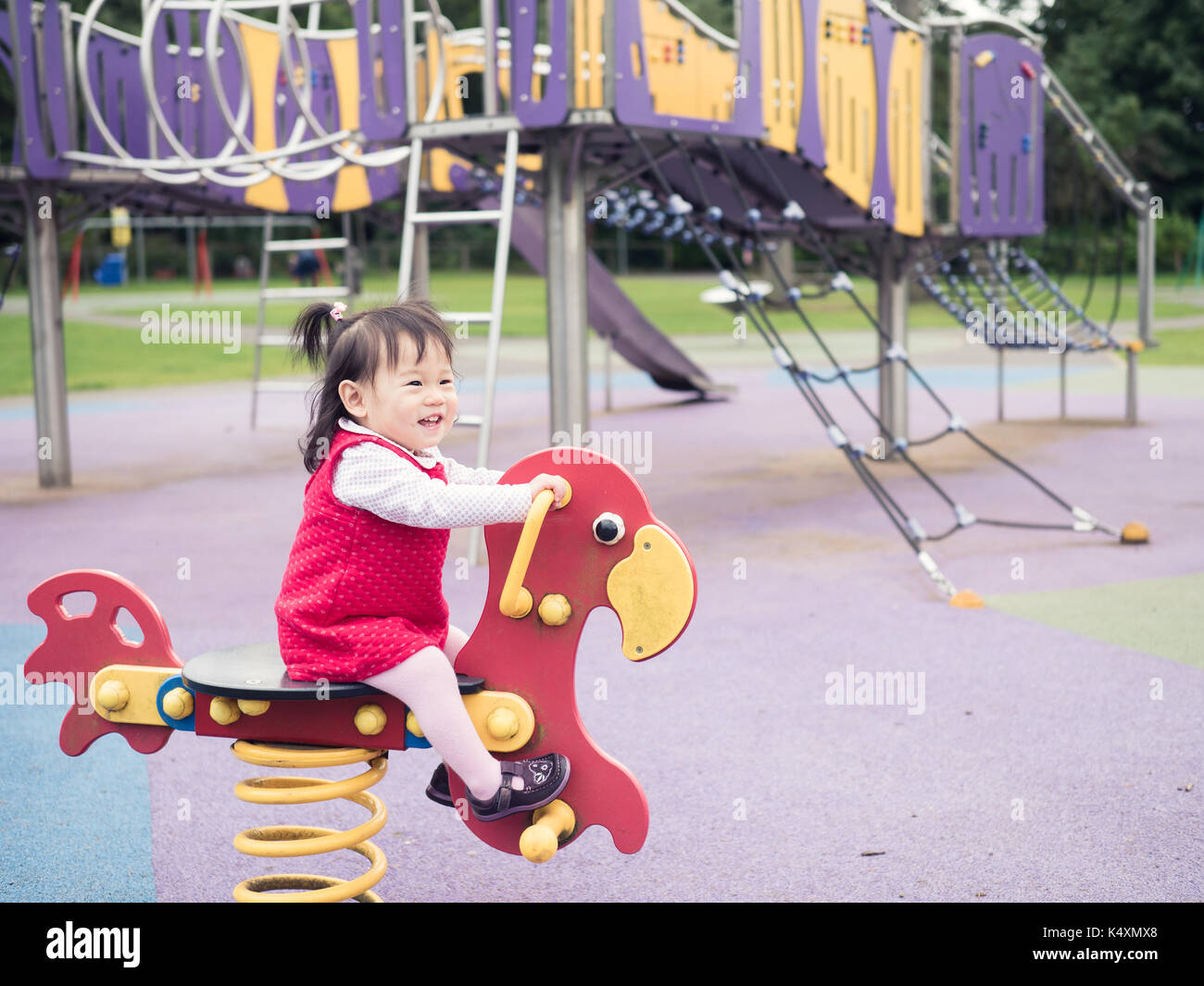 baby girl on rocking horse Stock Photo - Alamy