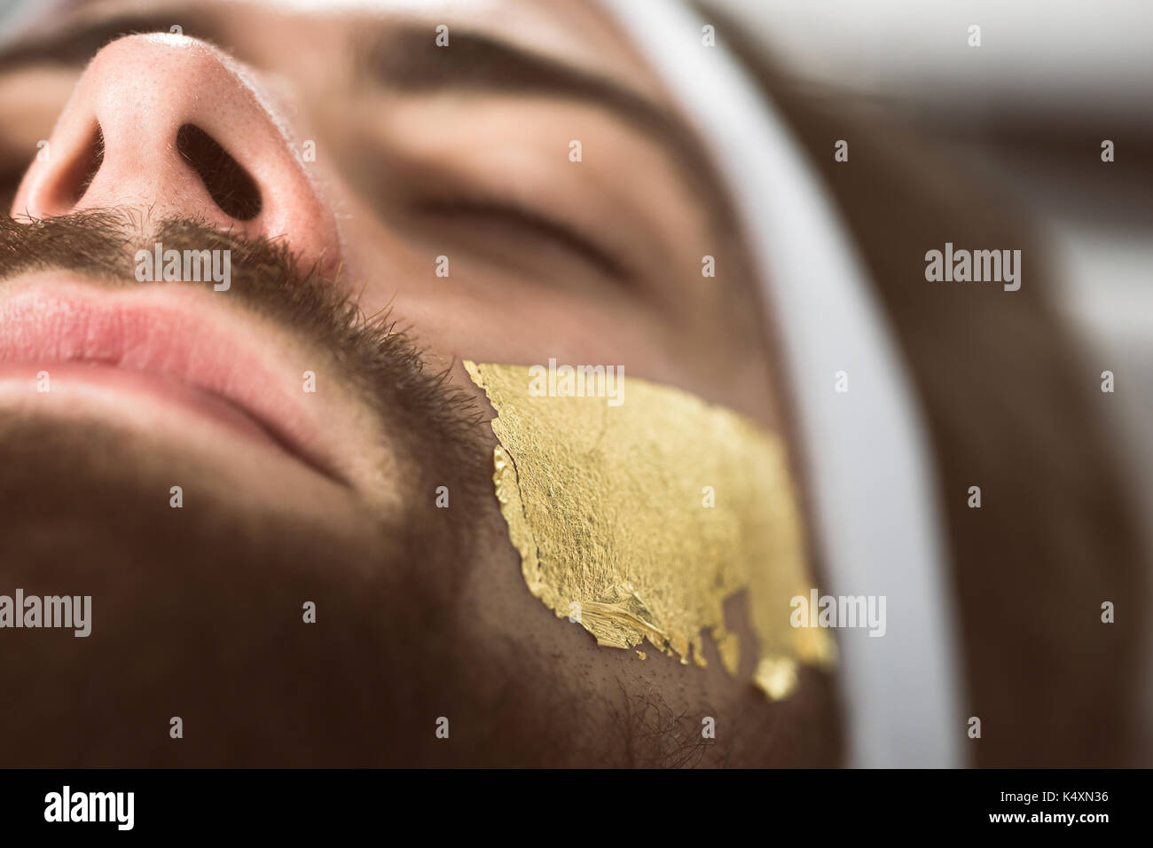 Gold mask leaf at man's face Stock Photo - Alamy