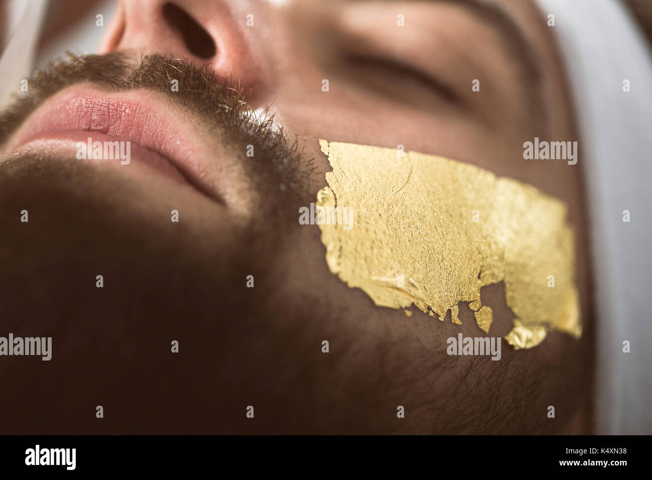 Gold mask leaf at man's face Stock Photo - Alamy