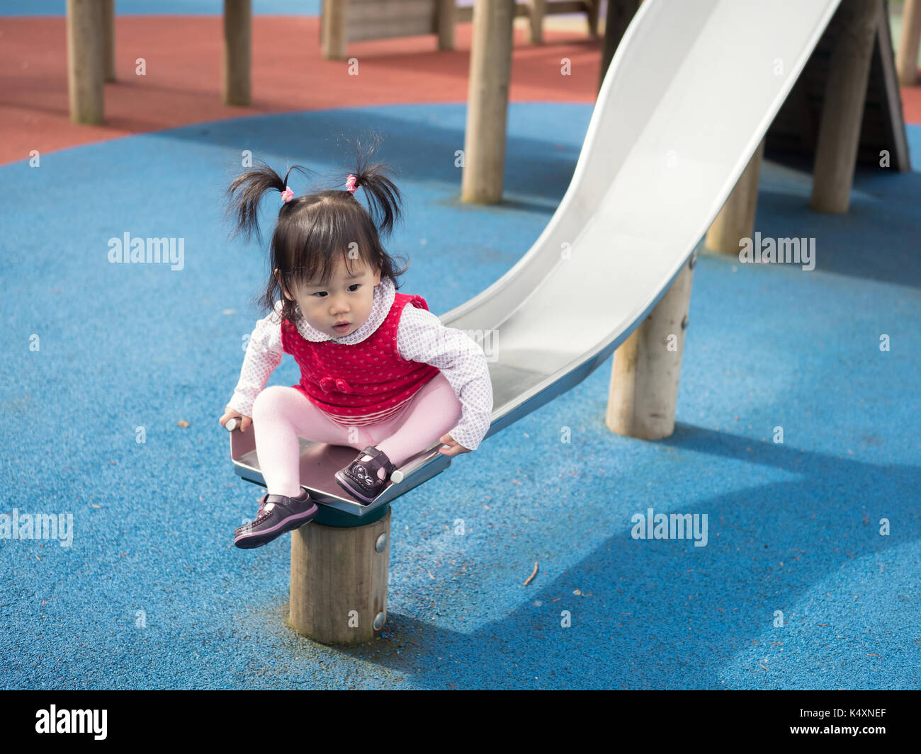 baby girl playing in the playground Stock Photo - Alamy