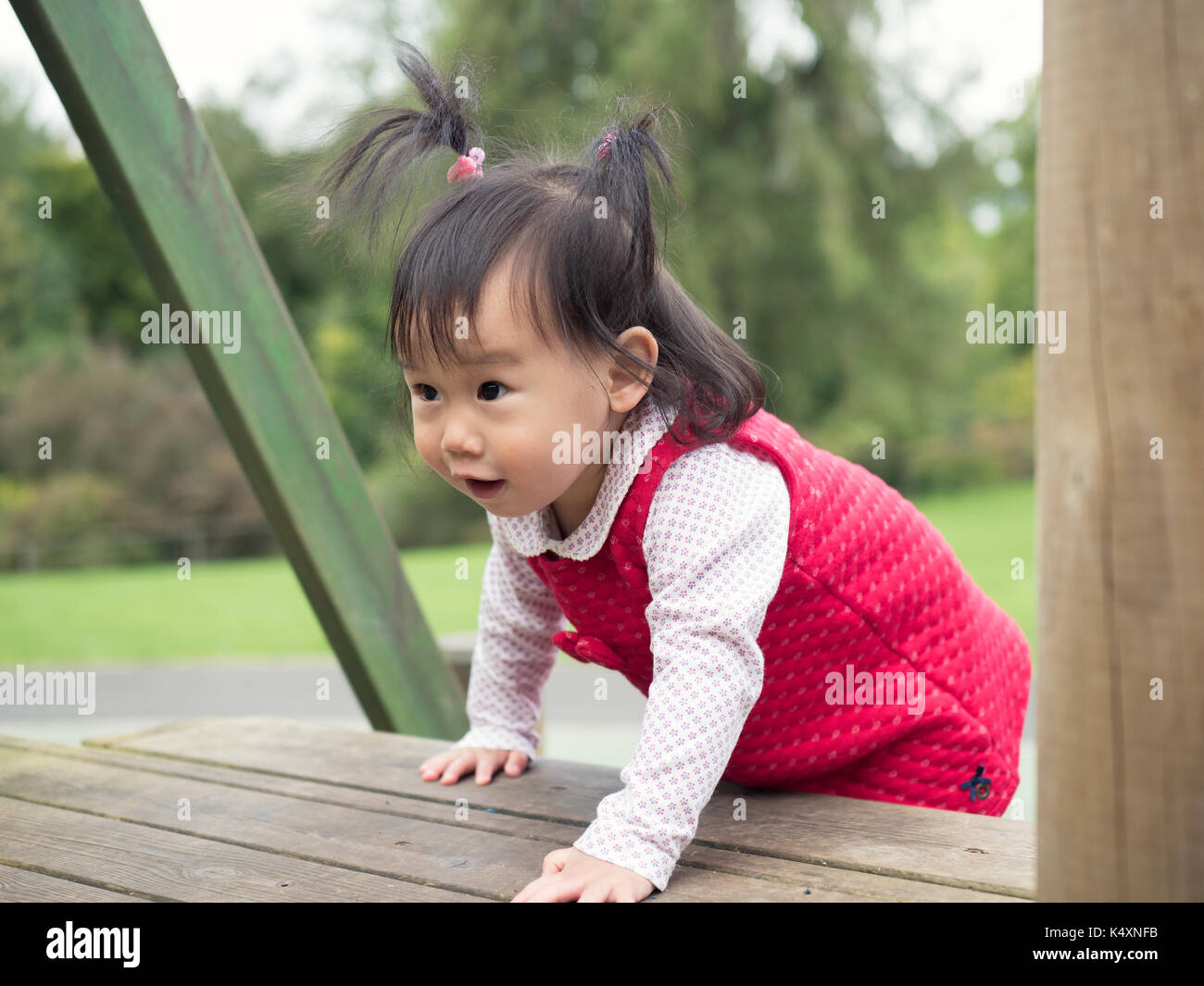baby girl playing in the playground Stock Photo - Alamy