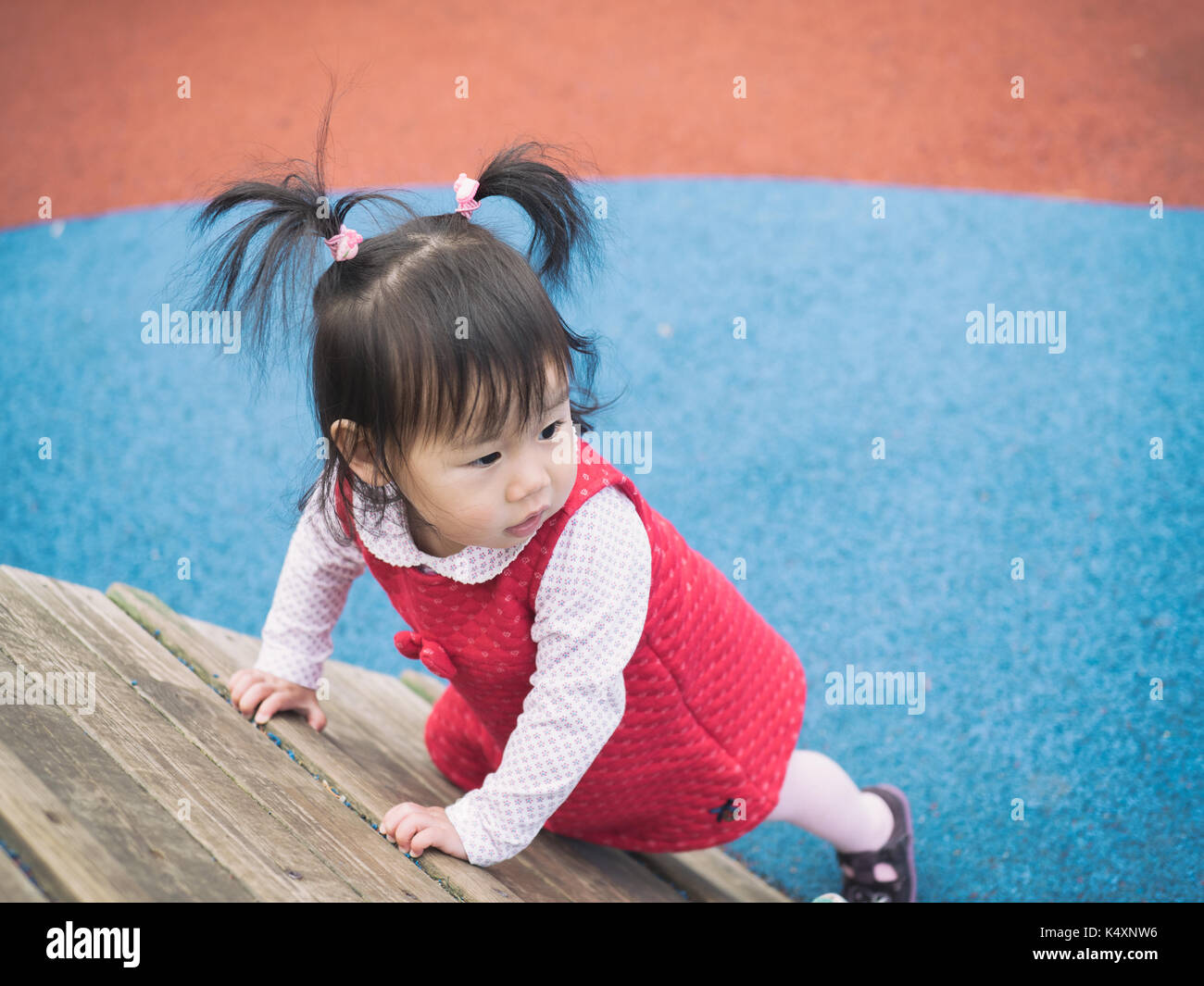 baby girl playing in the playground Stock Photo - Alamy