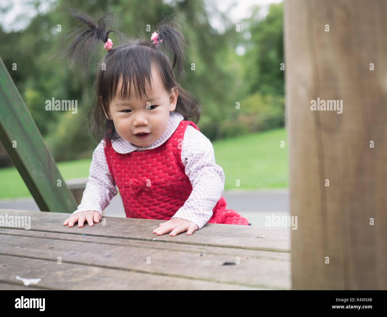 baby girl playing in the playground Stock Photo - Alamy