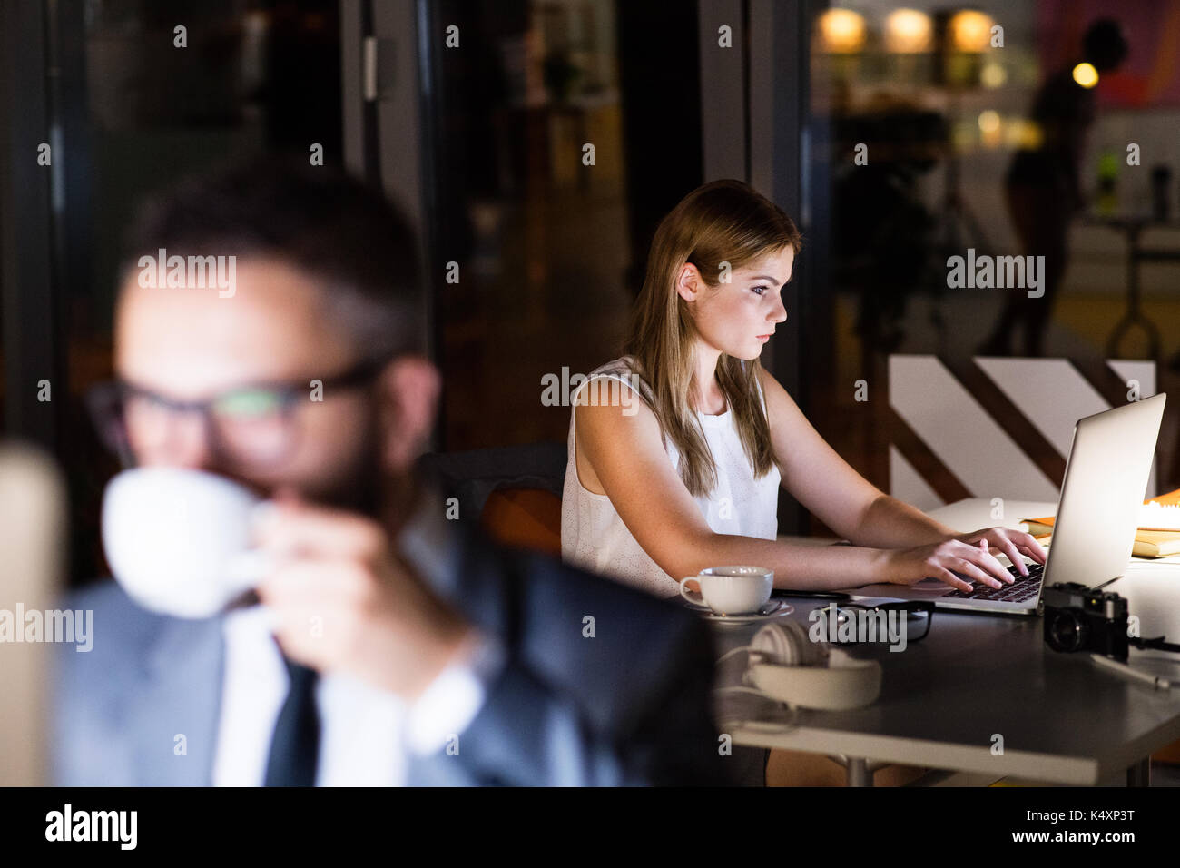 Businesspeople in the office at night working late Stock Photo - Alamy