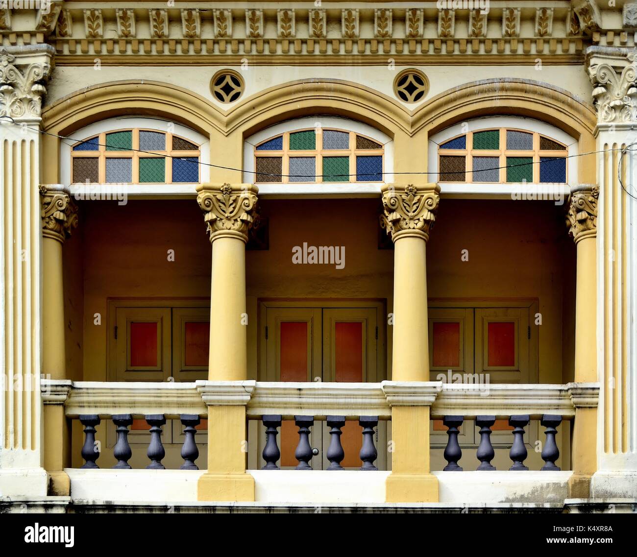 Traditional Singapore shop house exterior with arched windows and ...