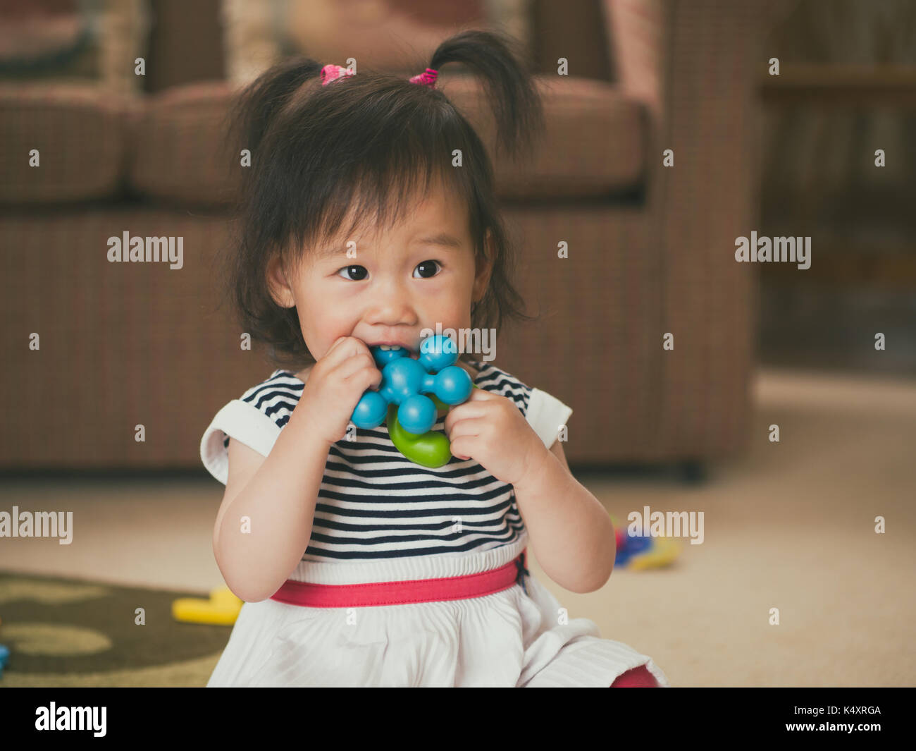 baby girl playing toy at home Stock Photo - Alamy
