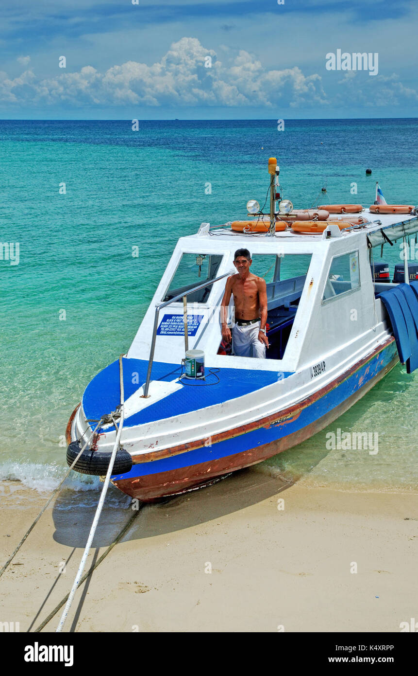 SELINGAN, MALAYSIA - MAY 08: An unidentified man on his boat to ...