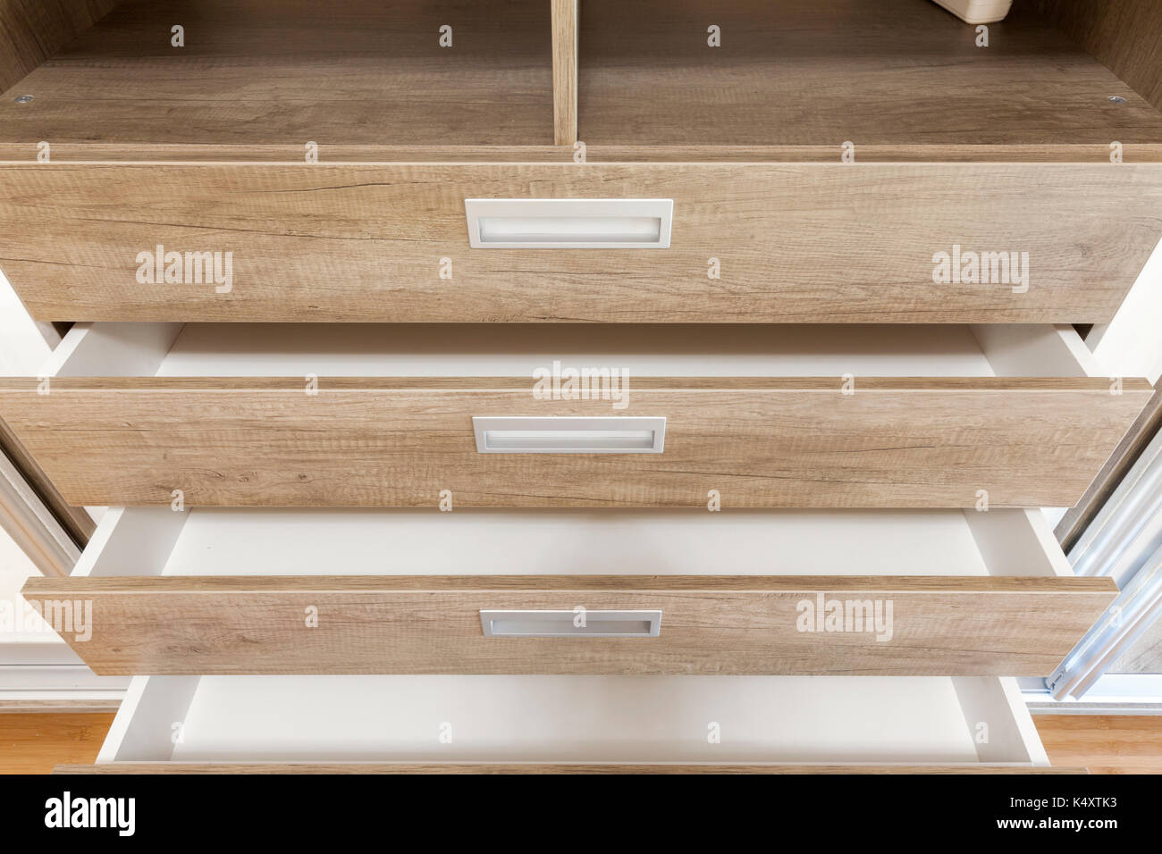 open wooden drawers in the closet, close up Stock Photo - Alamy