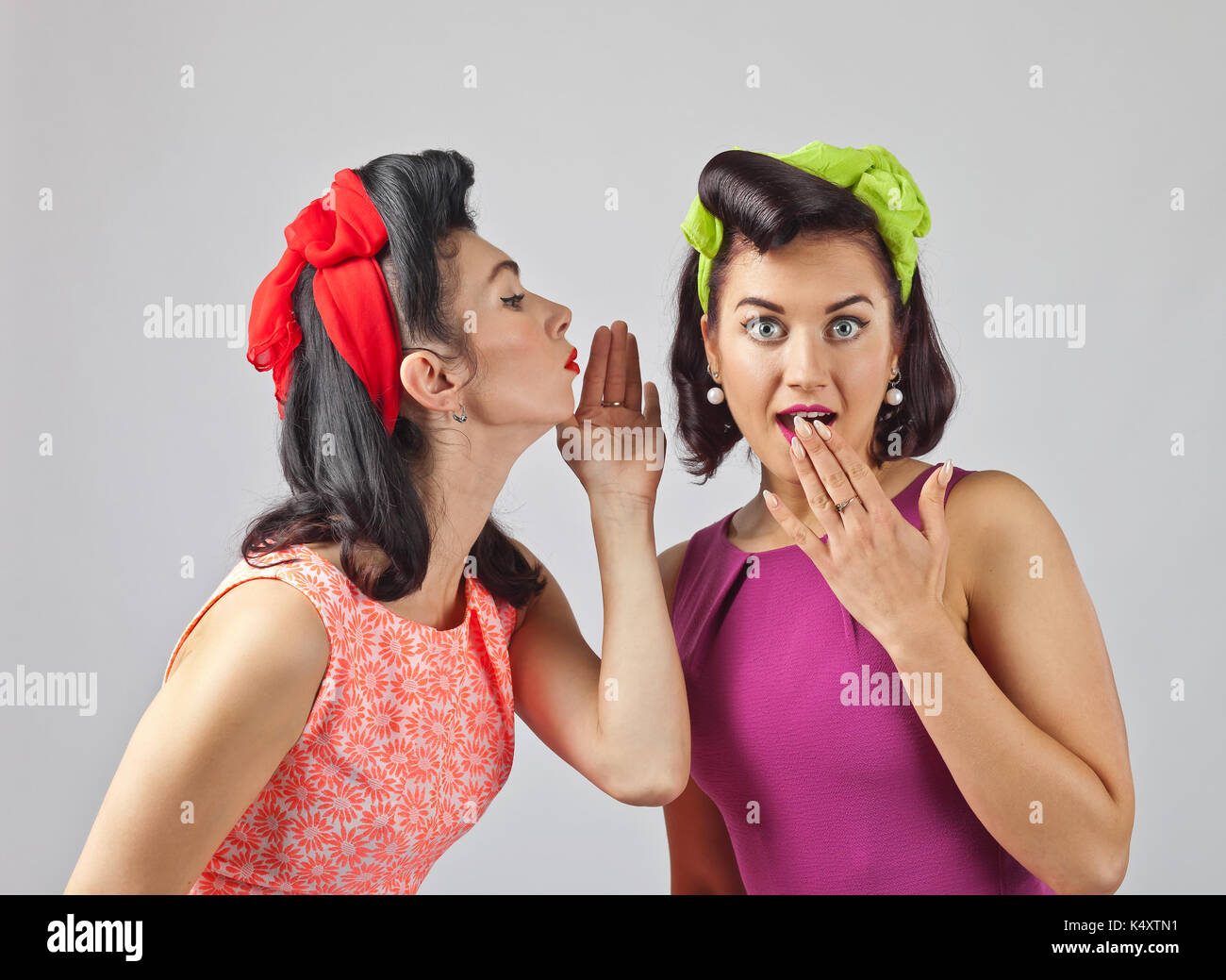 Beautiful women talking .Girls in pin up style with perfect hair and ...