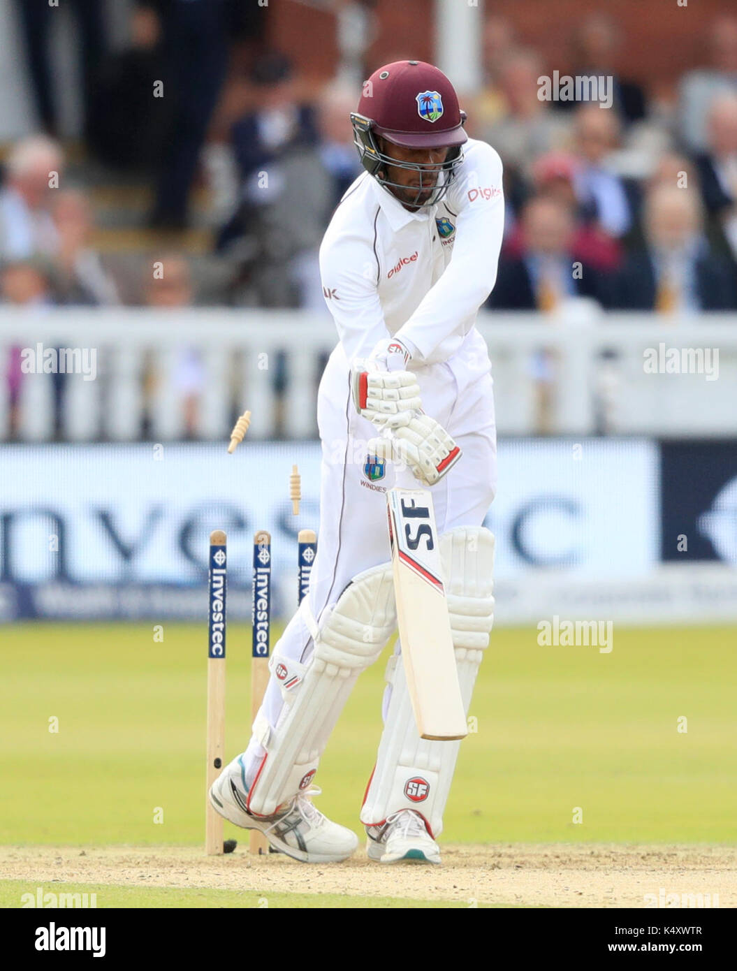 West Indies' Roston Chase is bowled by England's Ben Stokes during day ...
