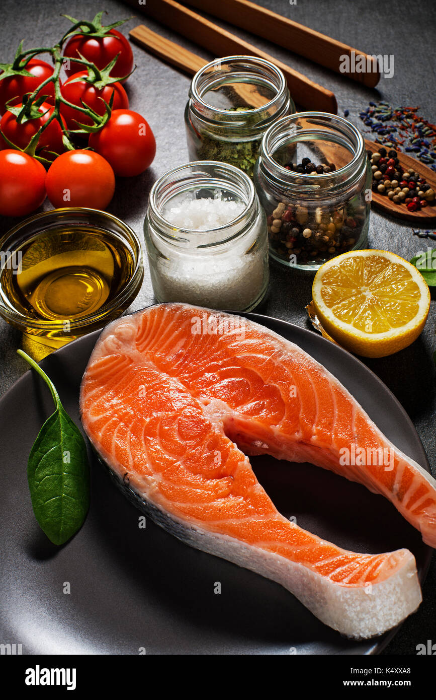 Selection of healthy food. Raw steak of salmon with fresh ingredients ...