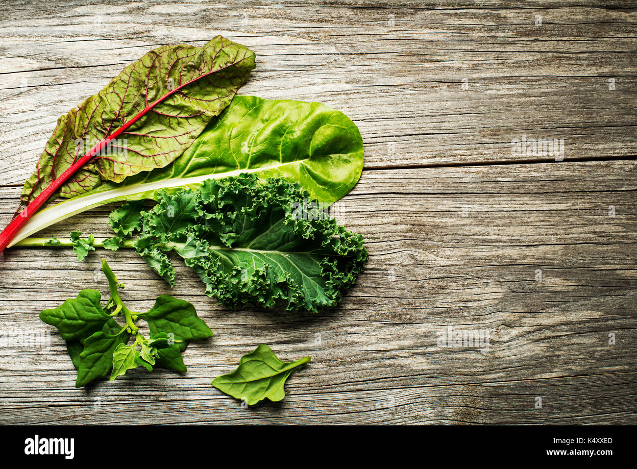 Vegetable healthy green leaves. Kale, swiss chard and spinach on wooden ...