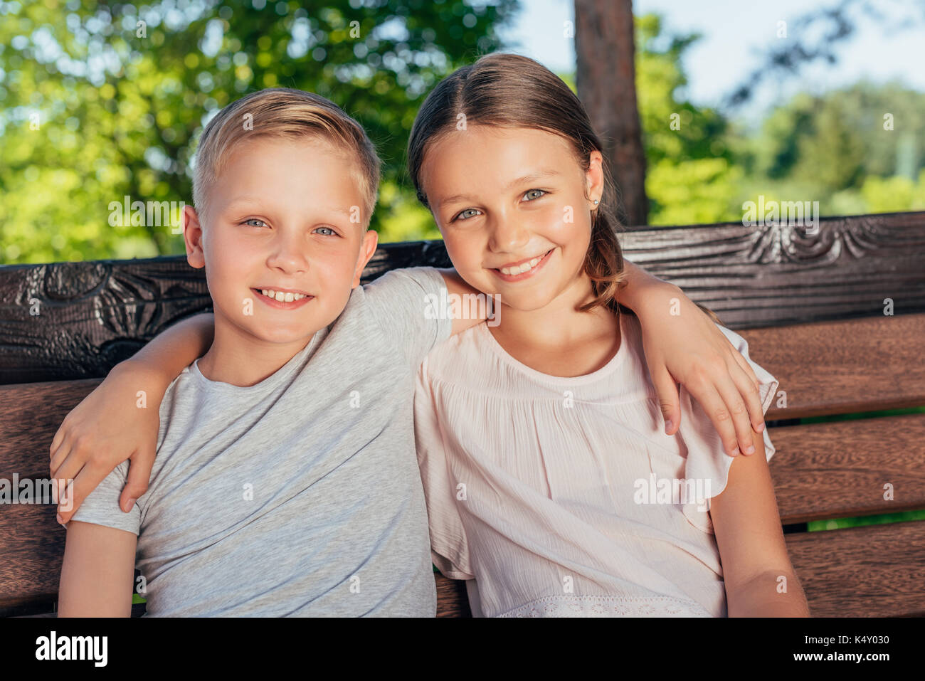 kids sitting on bench in park Stock Photo - Alamy