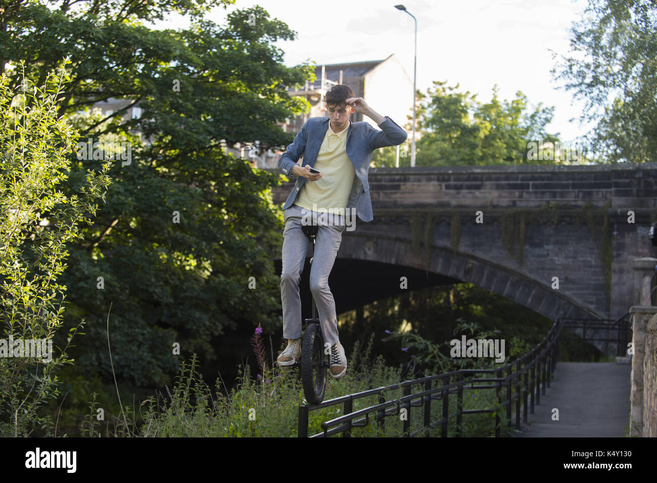 Sam Goodburn performs stunts in his unicycle on railings in front of ...