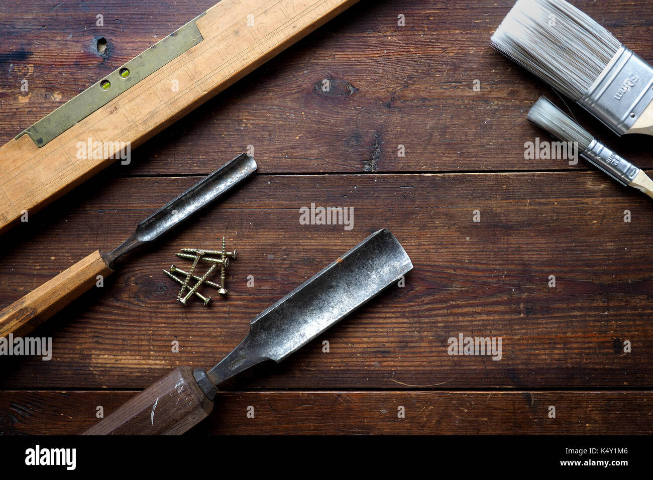 Wood chisels and spirit level on old table top Stock Photo - Alamy