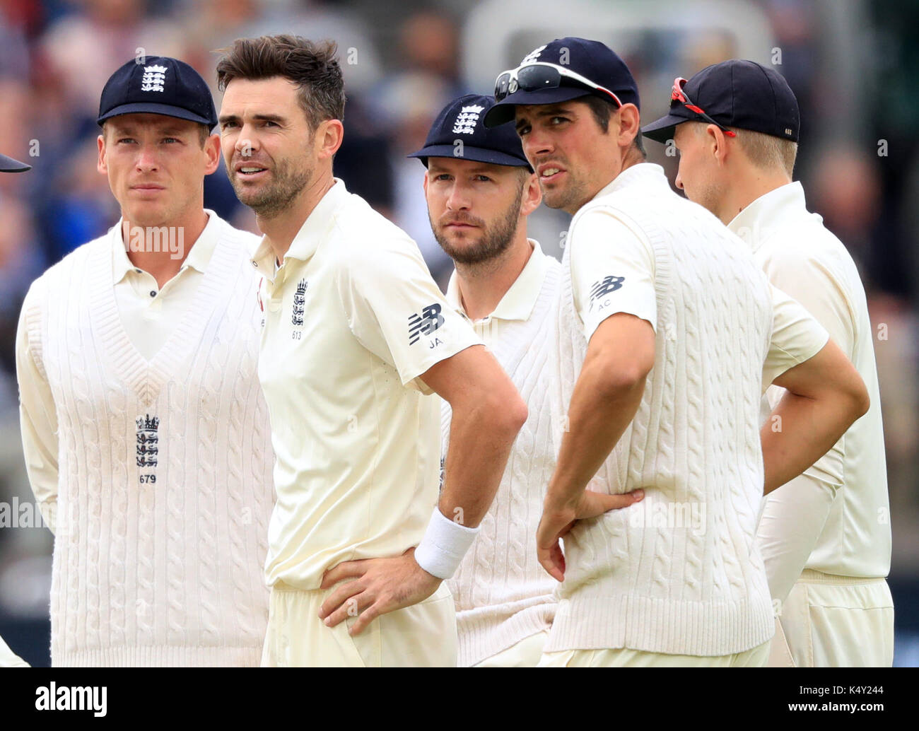 England's James Anderson (second left) watches the replay of his first ...
