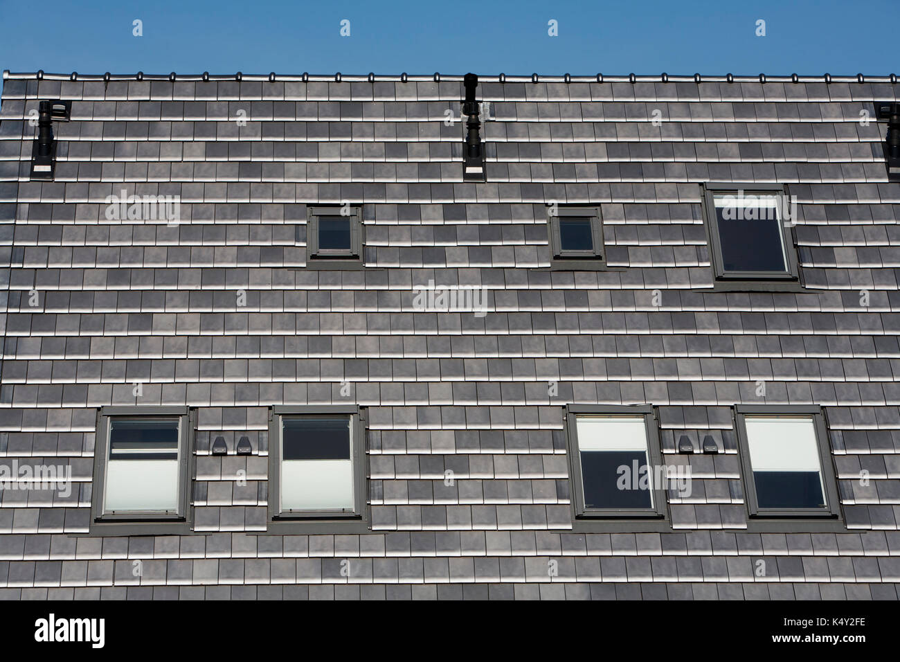 Stylish dark grey roof with skylights Stock Photo - Alamy