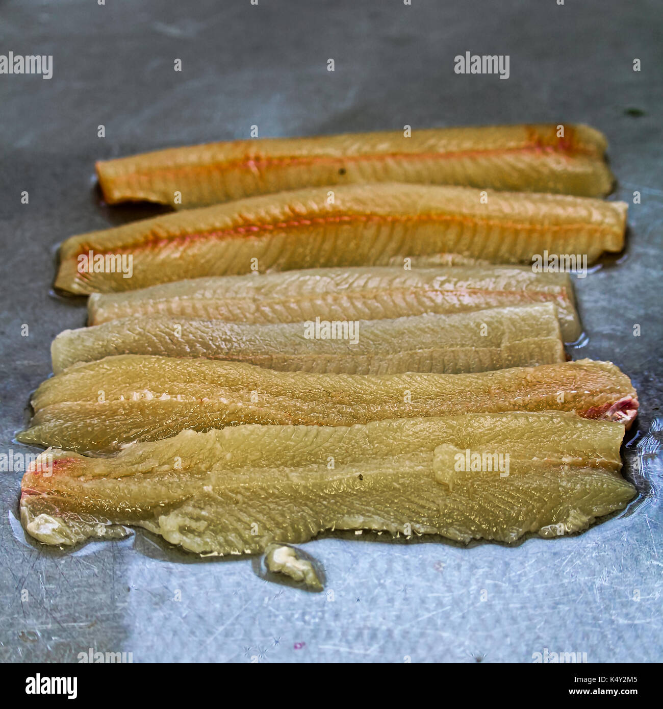 Six fillets of northern pike on a metal table Stock Photo - Alamy