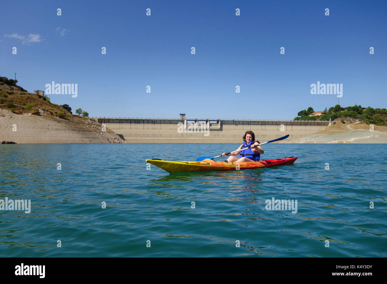 Young woman with a colorful kayak in a dam Stock Photo - Alamy