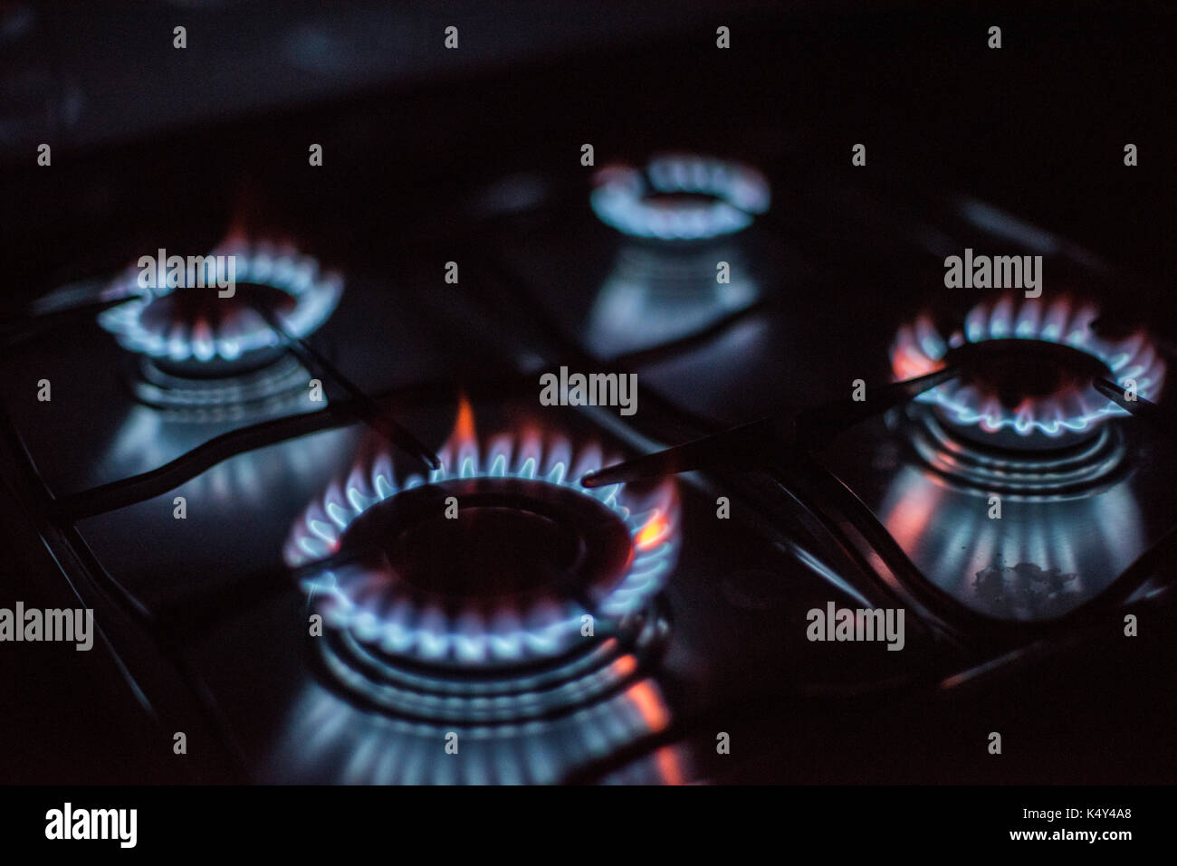 Rings of fire: four lighted gas stove burners Stock Photo - Alamy