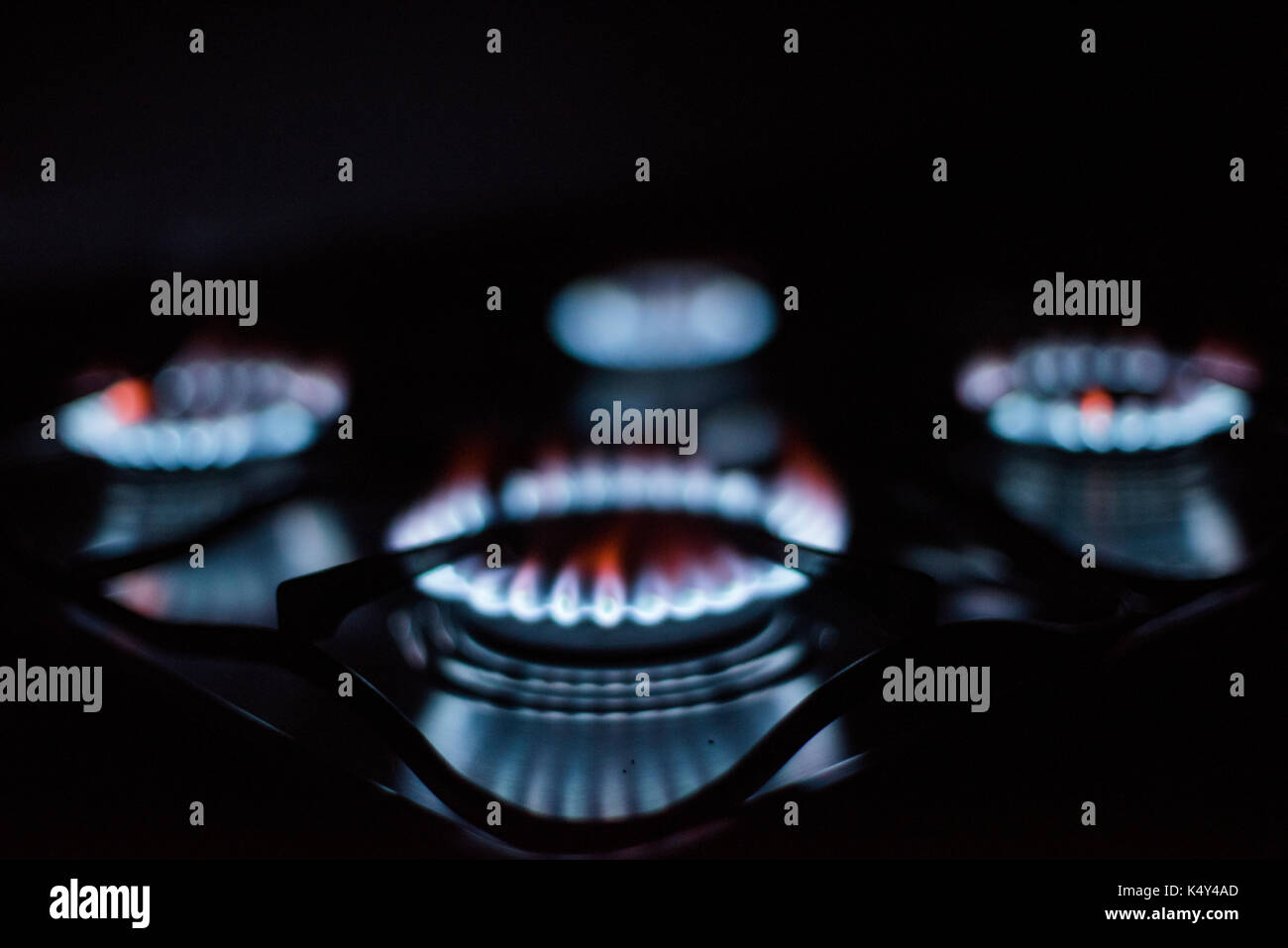 Rings of fire: four lighted gas stove burners Stock Photo - Alamy