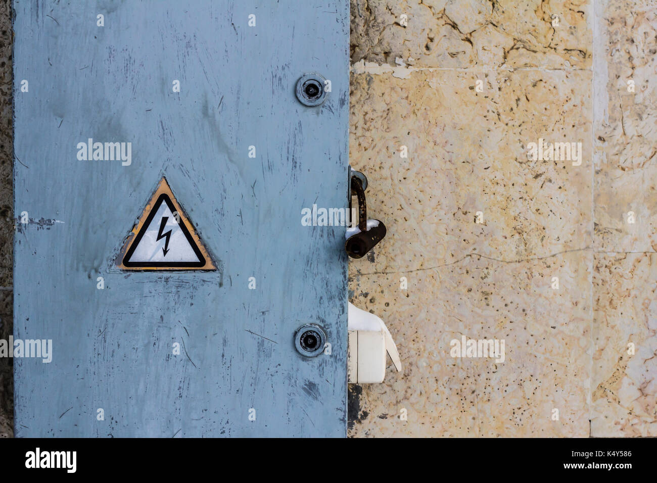 electrical hazard sign placed on a locked electric power dashboard on a ...