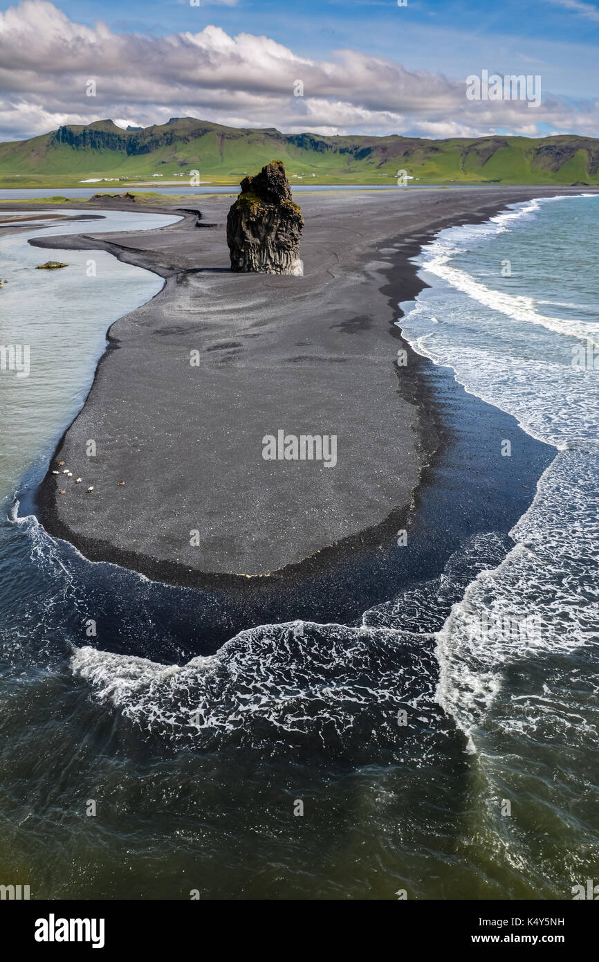 Rocks formation on Dyrholaey cape with black sand beach near Vik town ...
