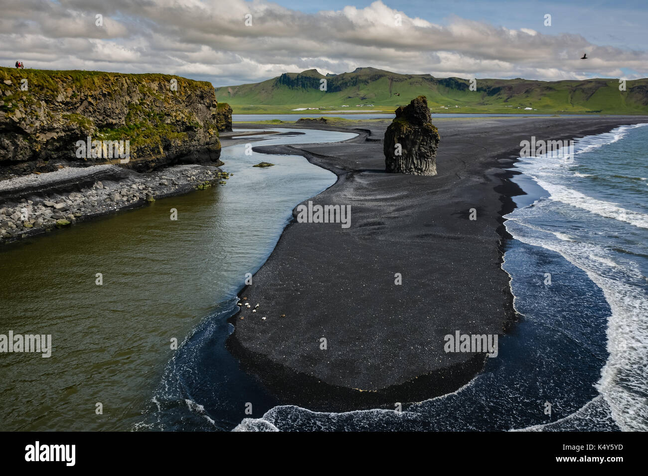 Rocks formation on Dyrholaey cape with black sand beach near Vik town ...