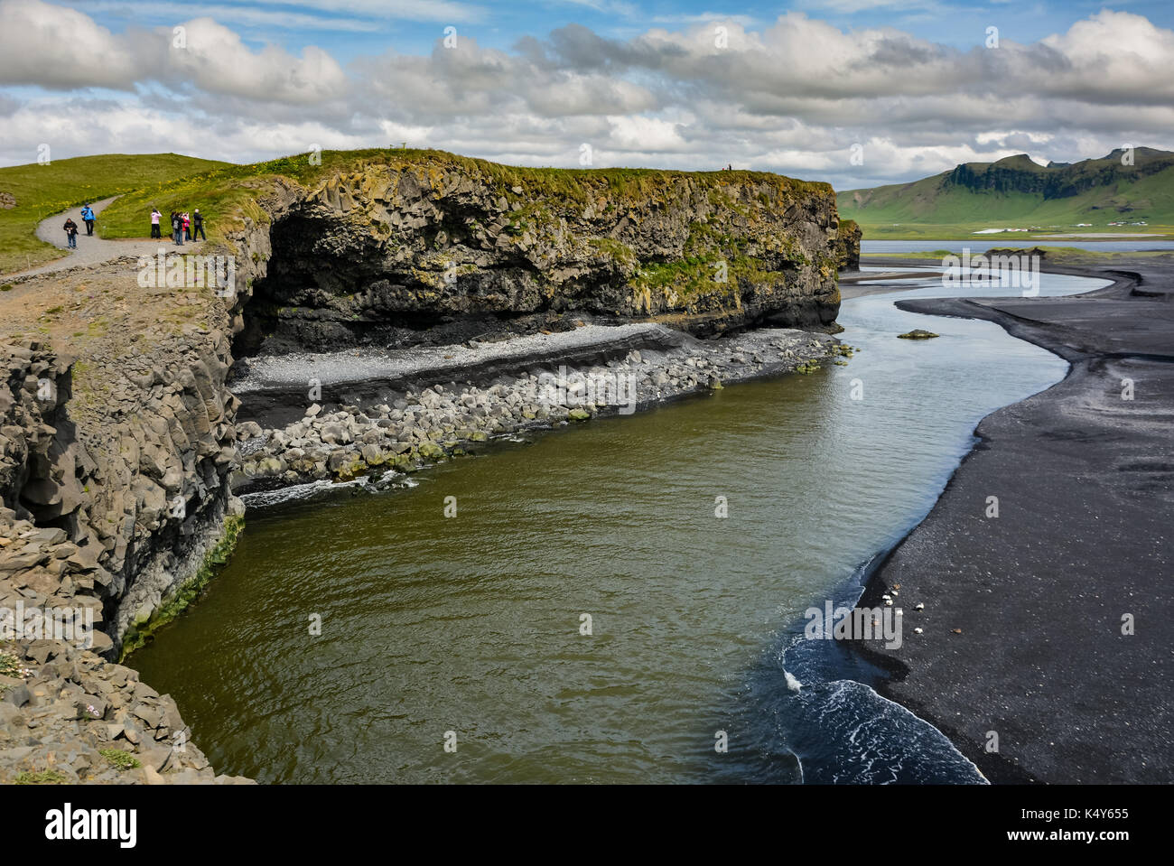 Rocks formation on Dyrholaey cape with black sand beach near Vik town ...