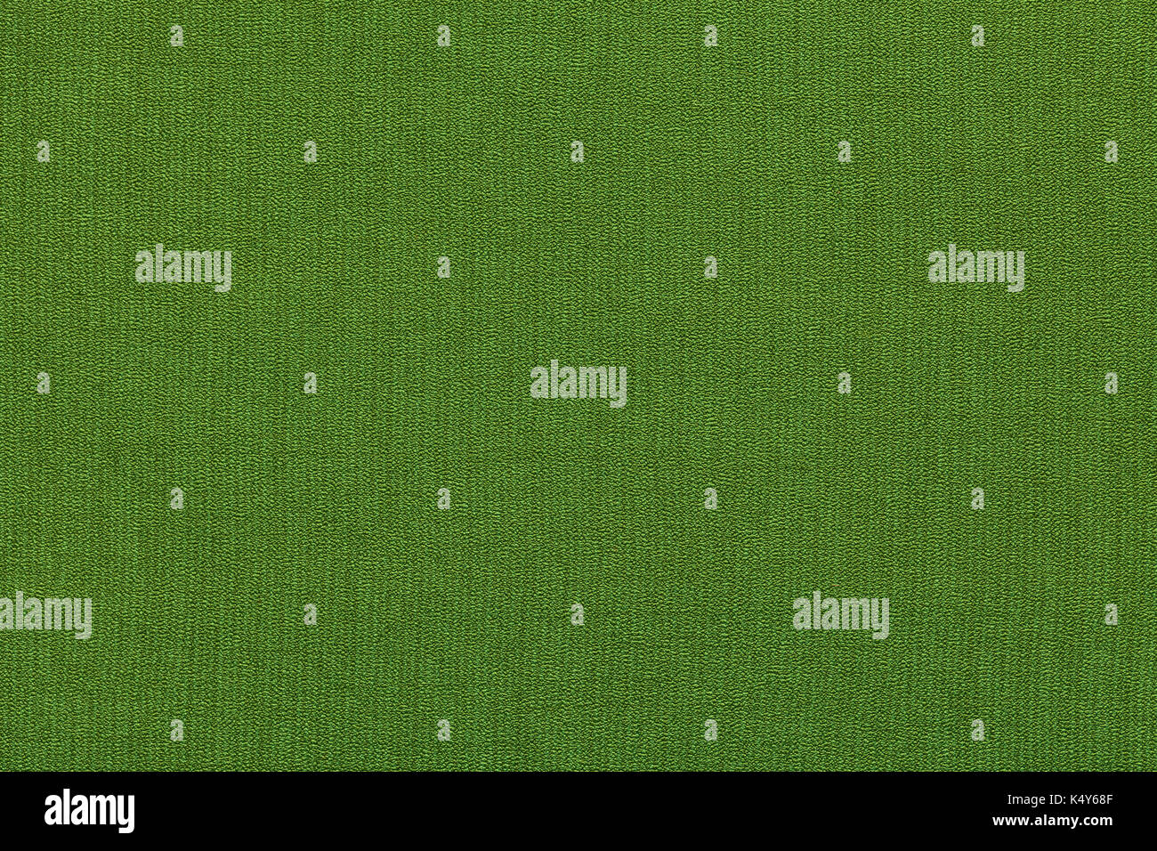 Green background from a textile material with pattern, closeup ...