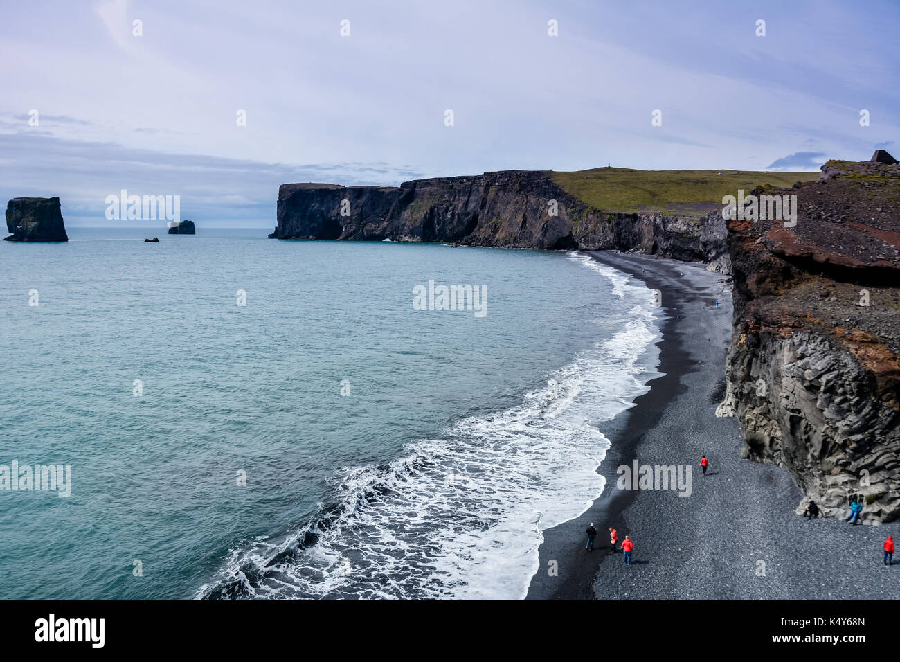 Rocks formation on Dyrholaey cape with black sand beach near Vik town ...