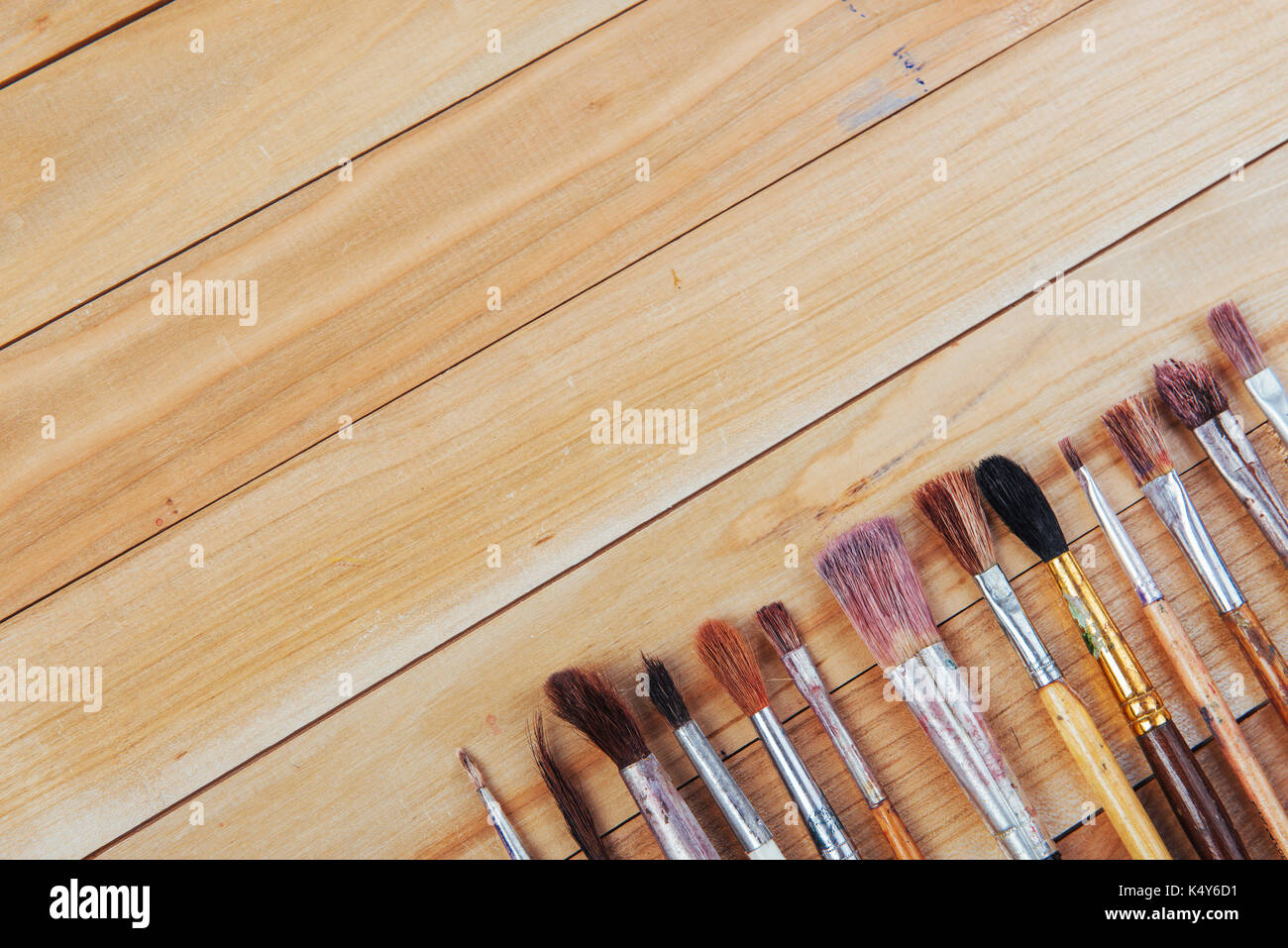 Paintbrushes and art tools on a wooden table background Stock Photo - Alamy