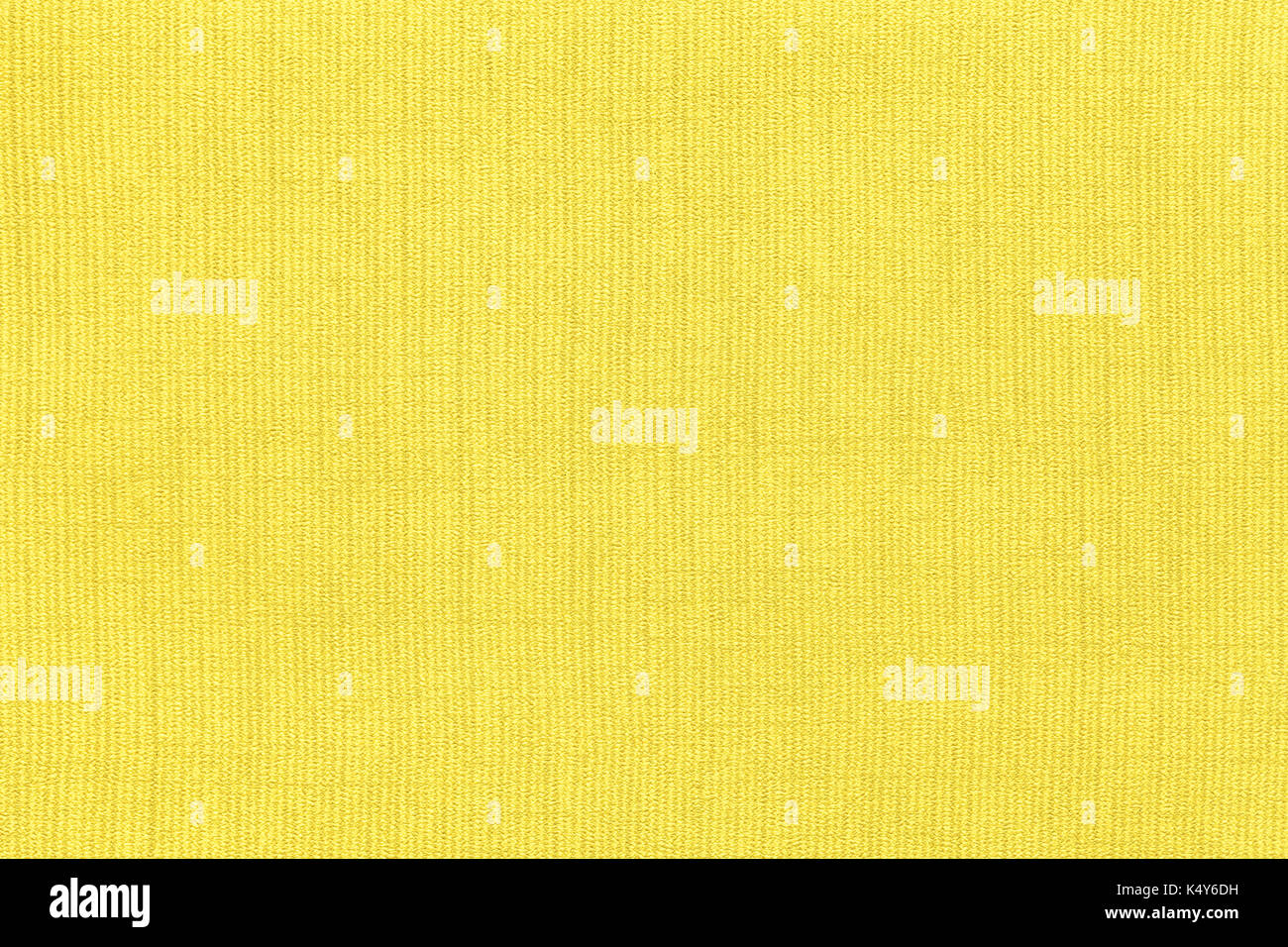 Light yellow background from a textile material with pattern, closeup ...