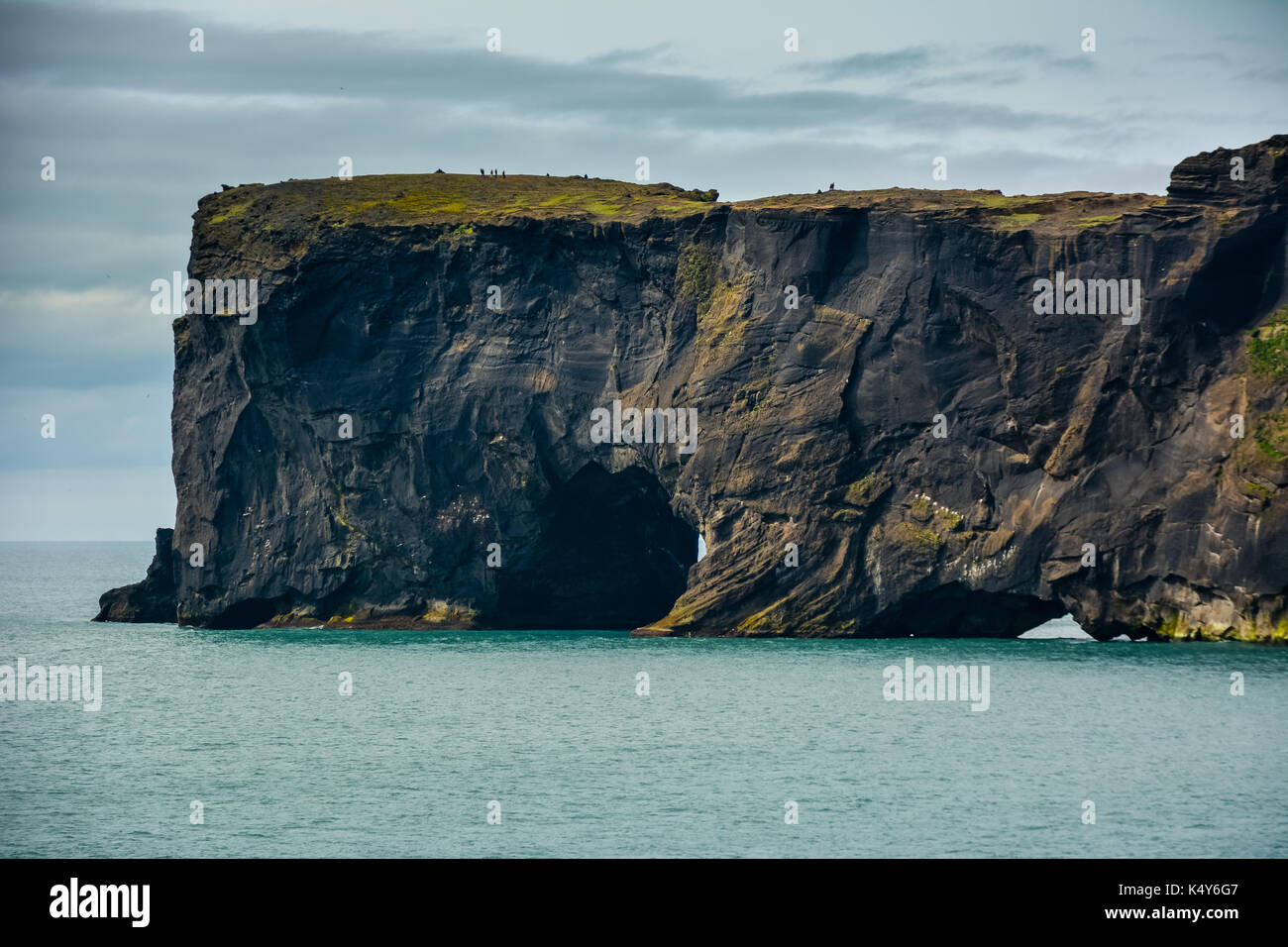 Rocks formation on Dyrholaey cape with black sand beach near Vik town ...