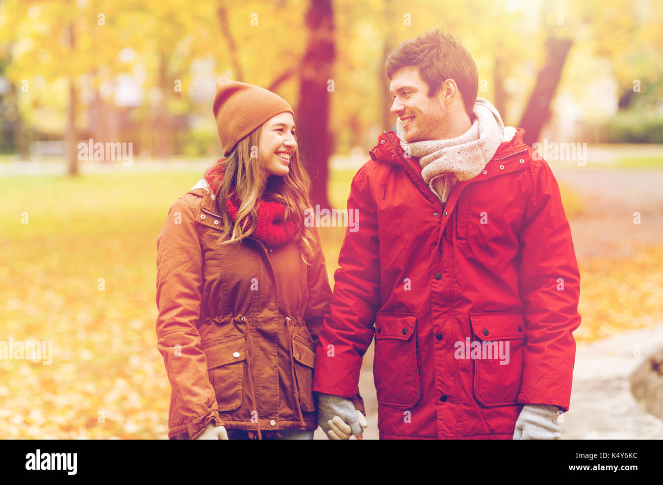 happy young couple walking in autumn park Stock Photo - Alamy