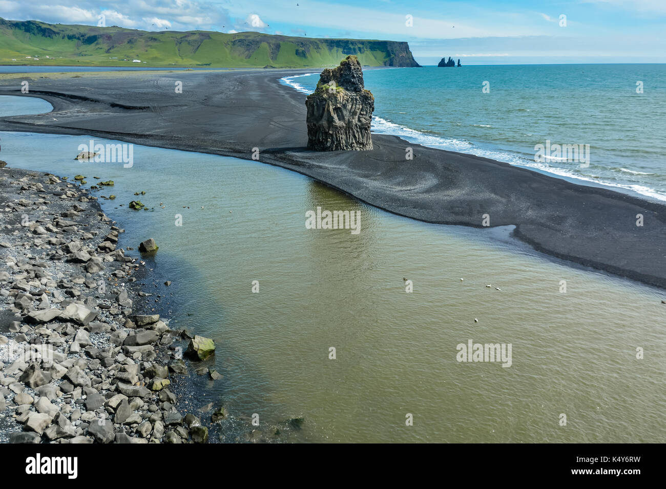 Rocks formation on Dyrholaey cape with black sand beach and puffins ...