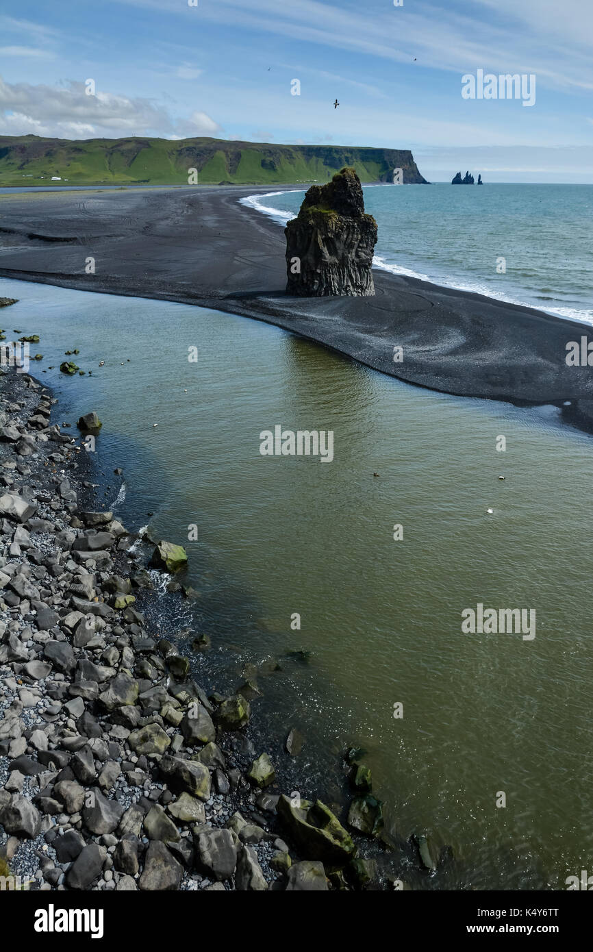 Rocks formation on Dyrholaey cape with black sand beach and puffins ...