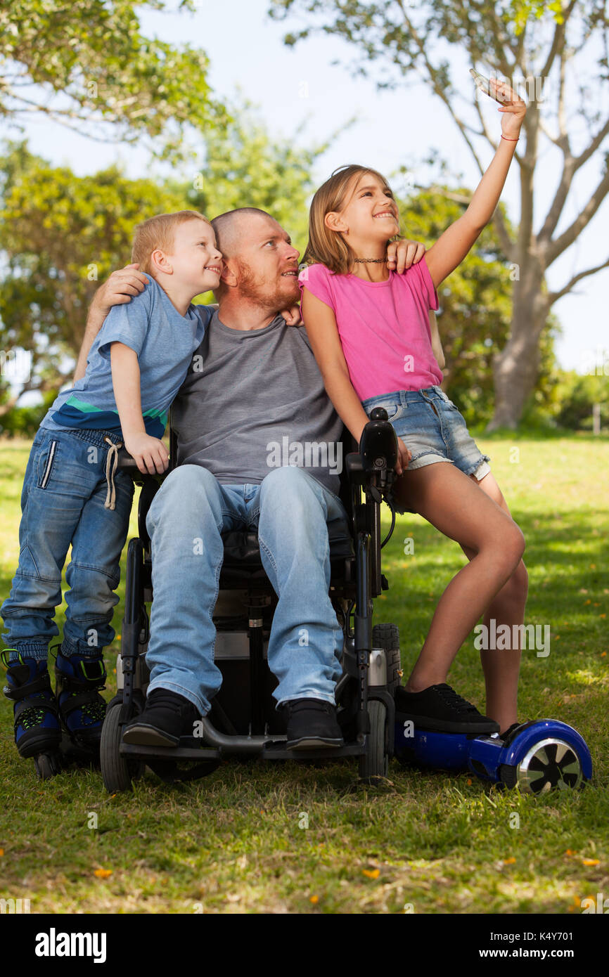 Disabled father doing selfie with children Stock Photo - Alamy