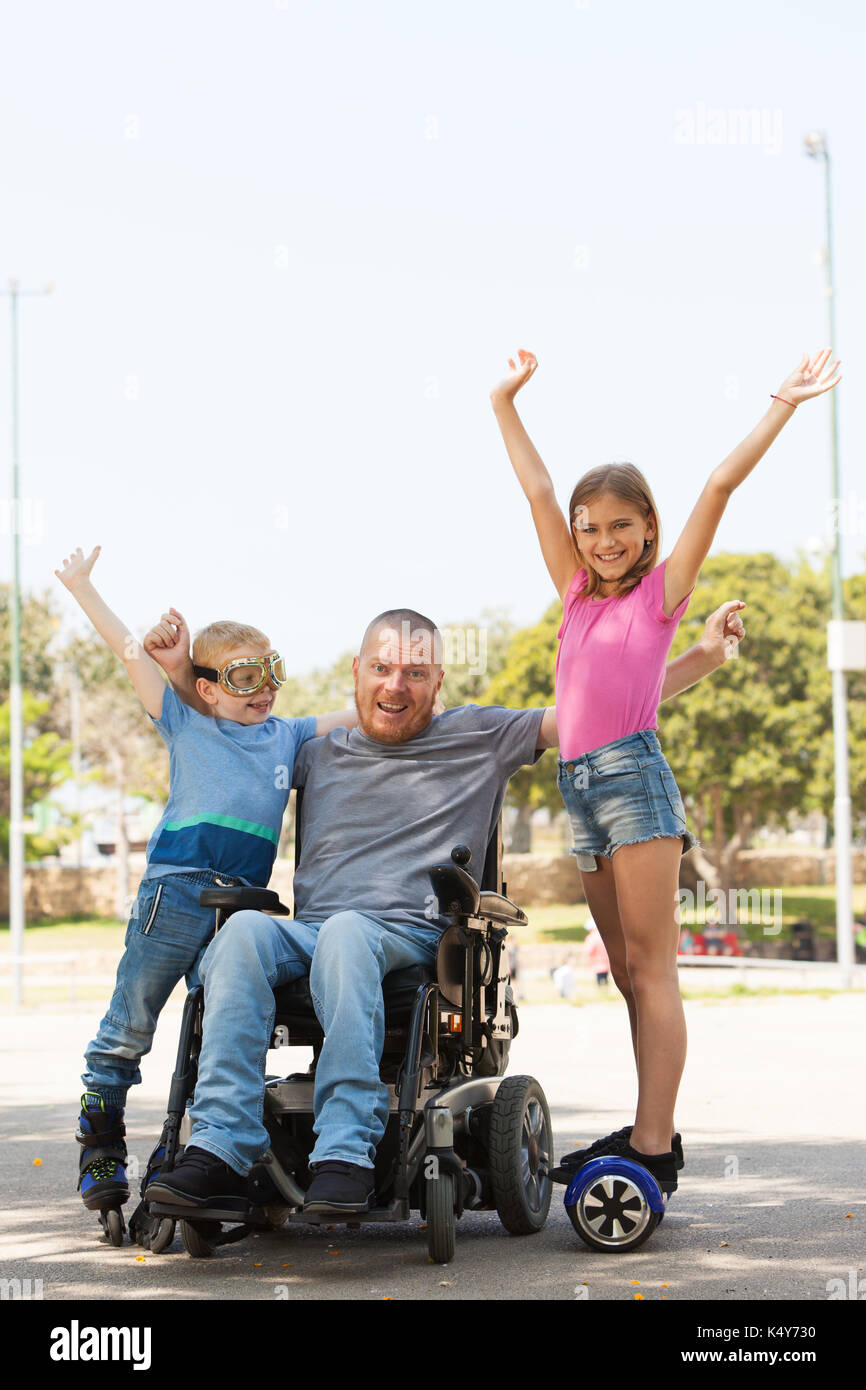 Disabled father on the wheelchair playing with children Stock Photo - Alamy