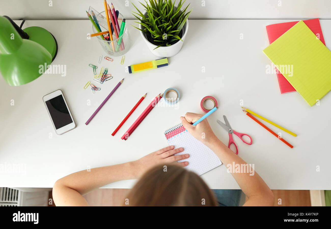 girl drawing in notebook at home Stock Photo - Alamy