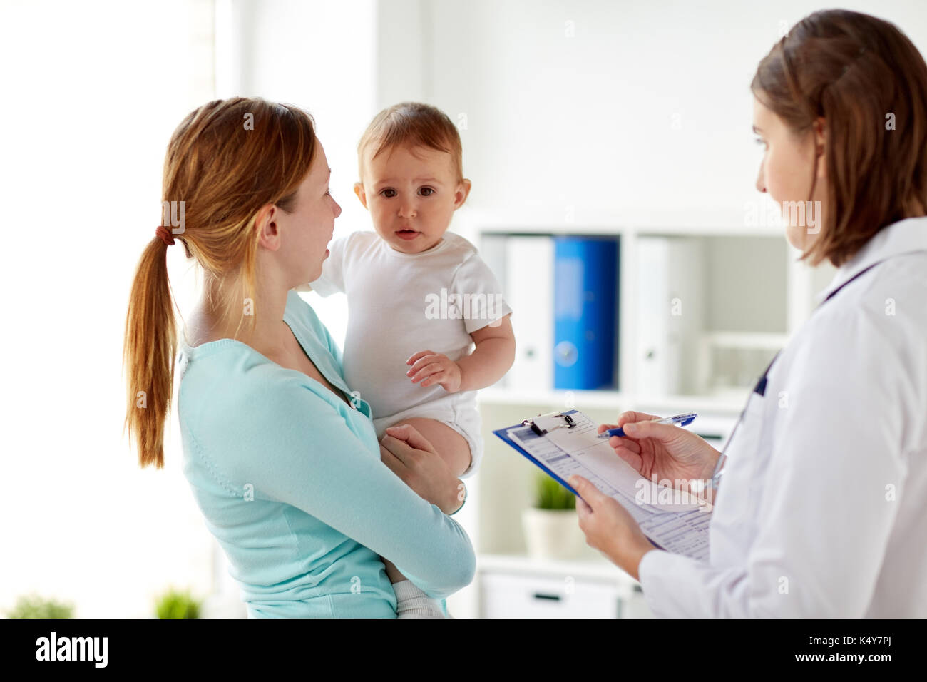 happy woman with baby and doctor at clinic Stock Photo - Alamy