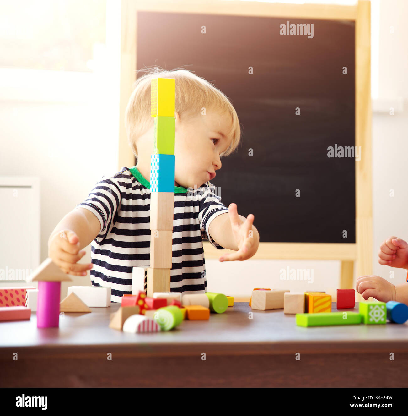 Child smiling building blocks tower hi-res stock photography and images ...