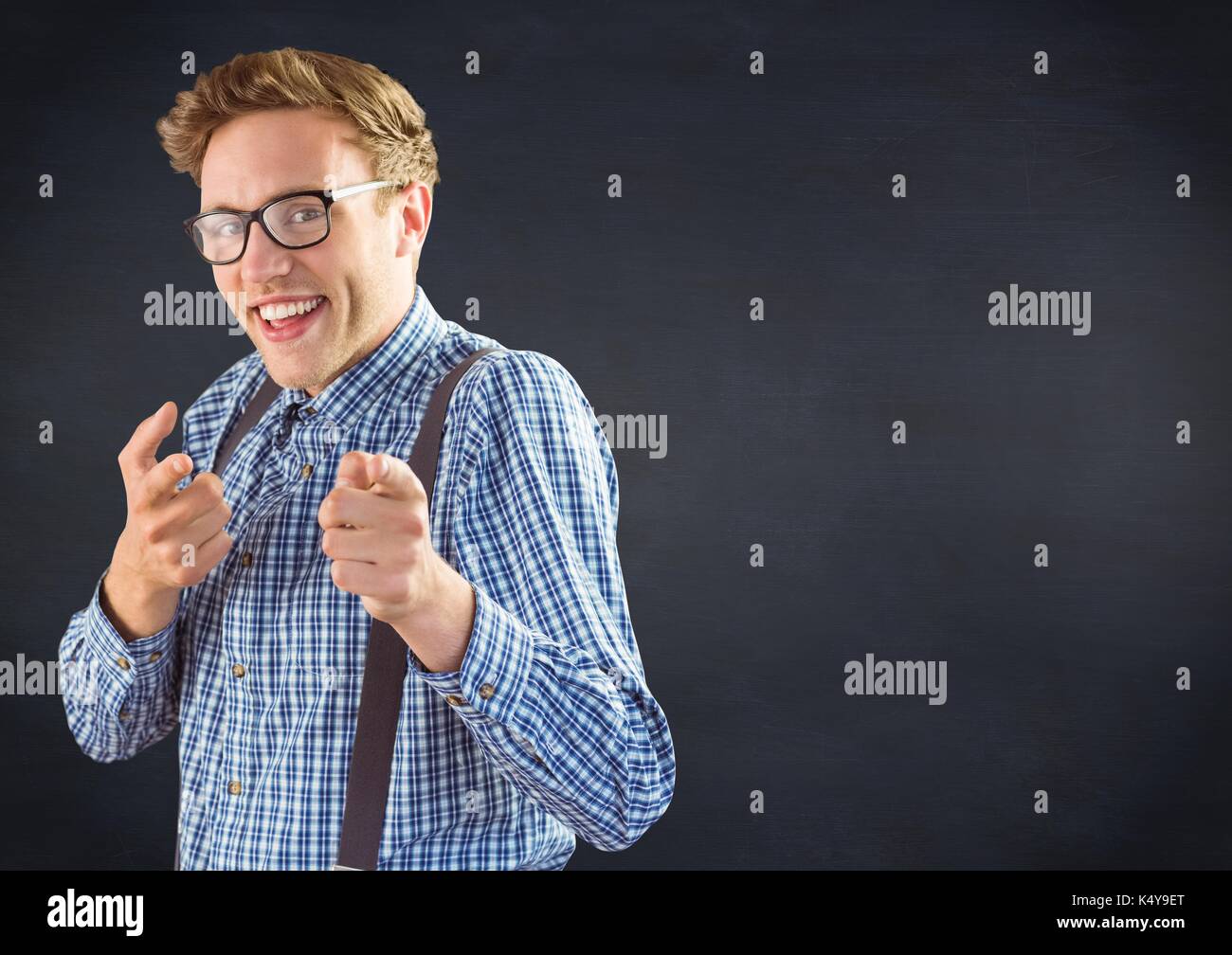 Digital composite of Nerd man pointing against navy chalkboard Stock ...